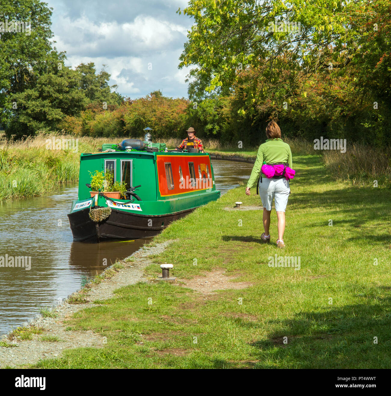 Woman walking along the towpath of the Llangollen canal with a ...