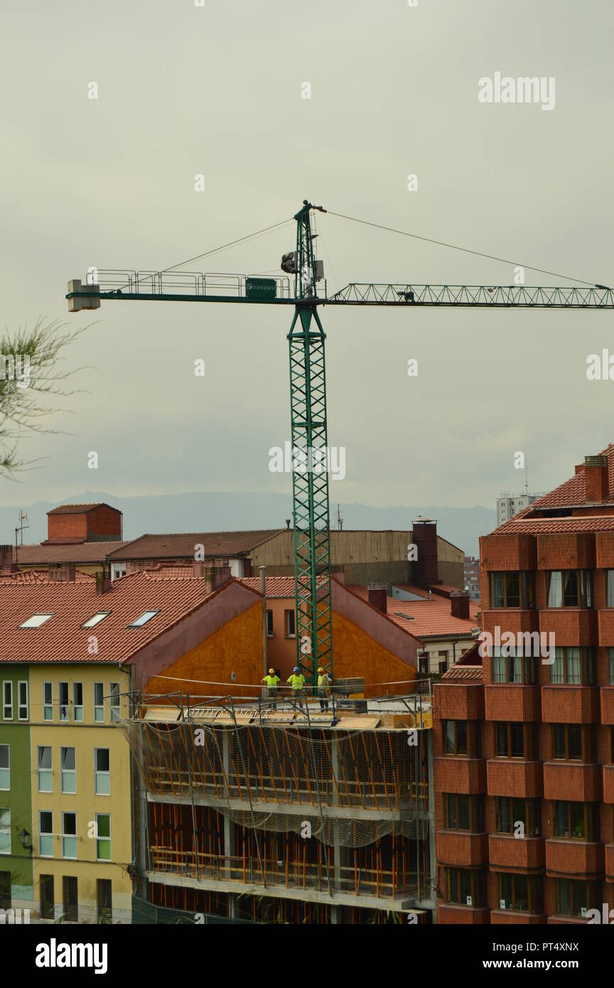 Bricklayers, Carpenters And Crane Operators Performing Their Work In A ...