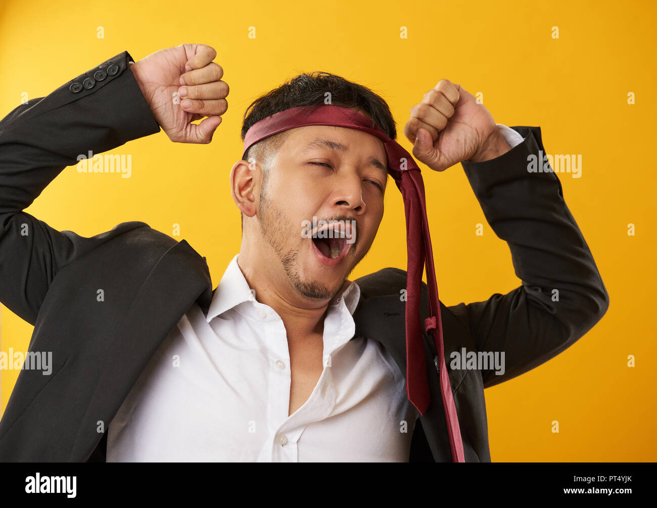 Drunk asian guy yawning color background Stock Photo - Alamy