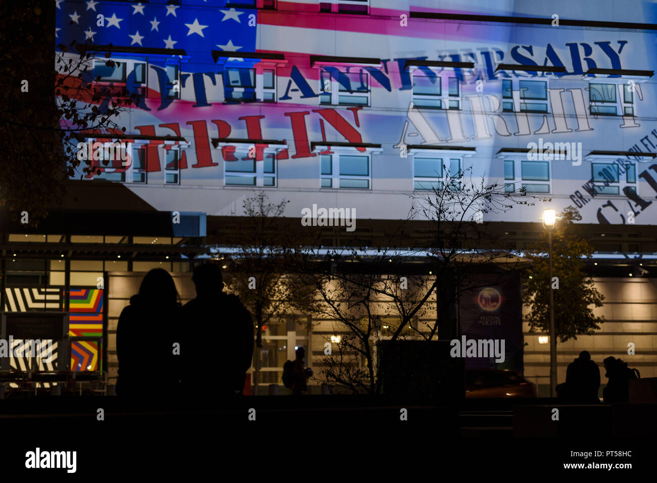 Silhouettes of people can be seen in front of the illuminated Embassy ...