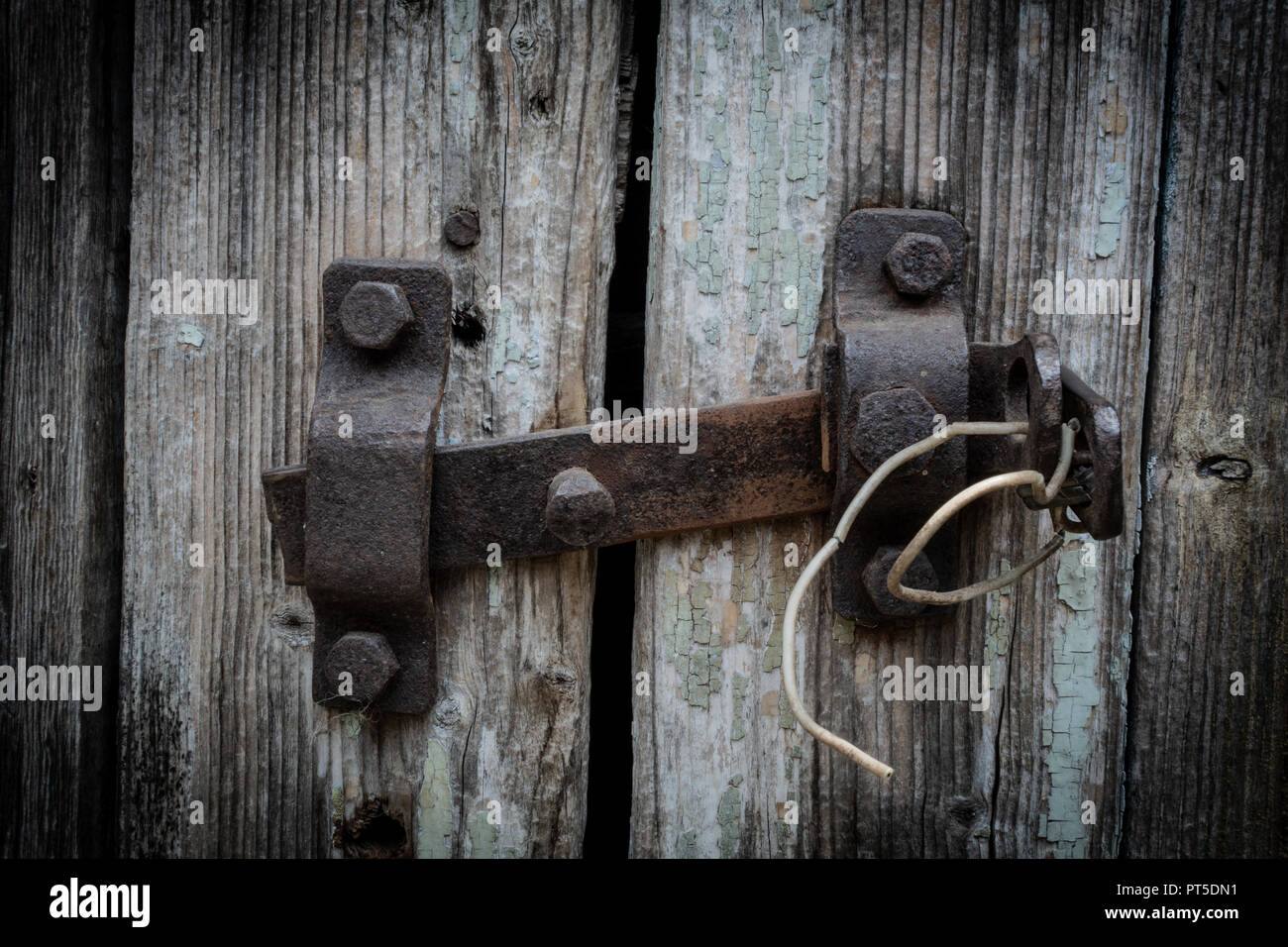 Rusty door bolt on grey wooden door Stock Photo - Alamy