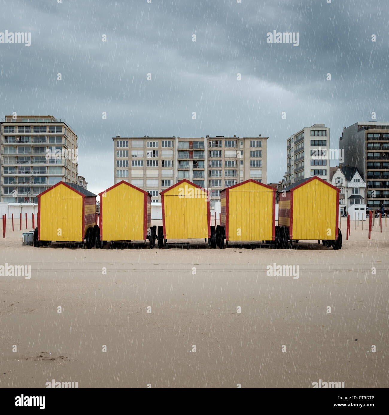 Row of colorful beach huts in the rain Stock Photo - Alamy