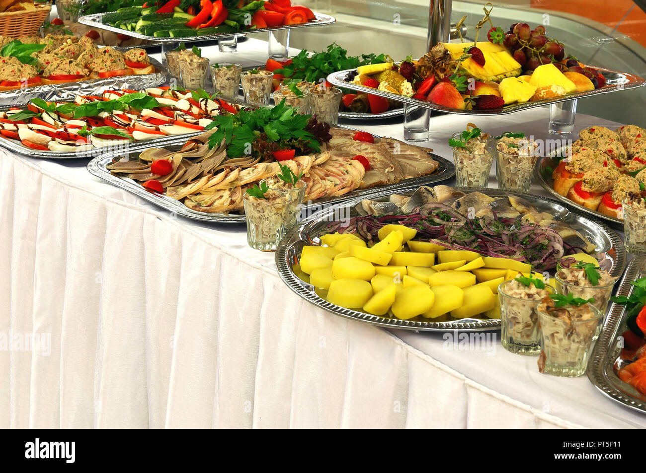 Table with sandwiches, snacks, appetizers and pickles on a white ...