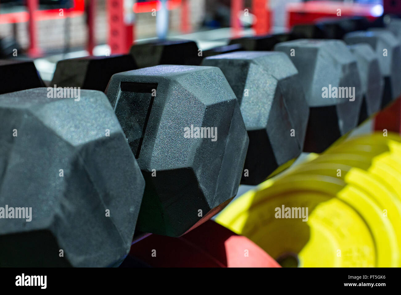 Black rubber dumbbells. Hexagonal heavy duty weight set used for ...