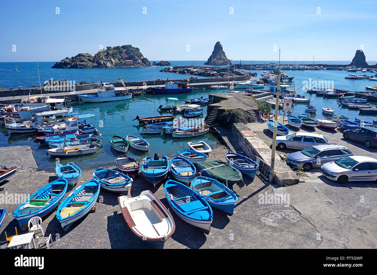Harbour of fishing village Aci Trezza, behind the cyclops islands ...