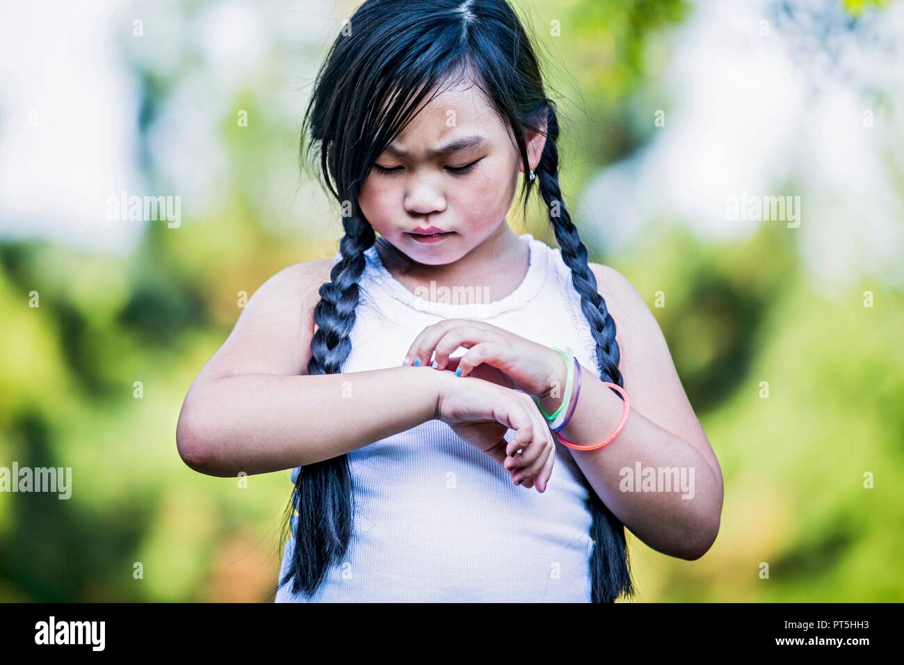 Girl scratching her hand in park Stock Photo - Alamy