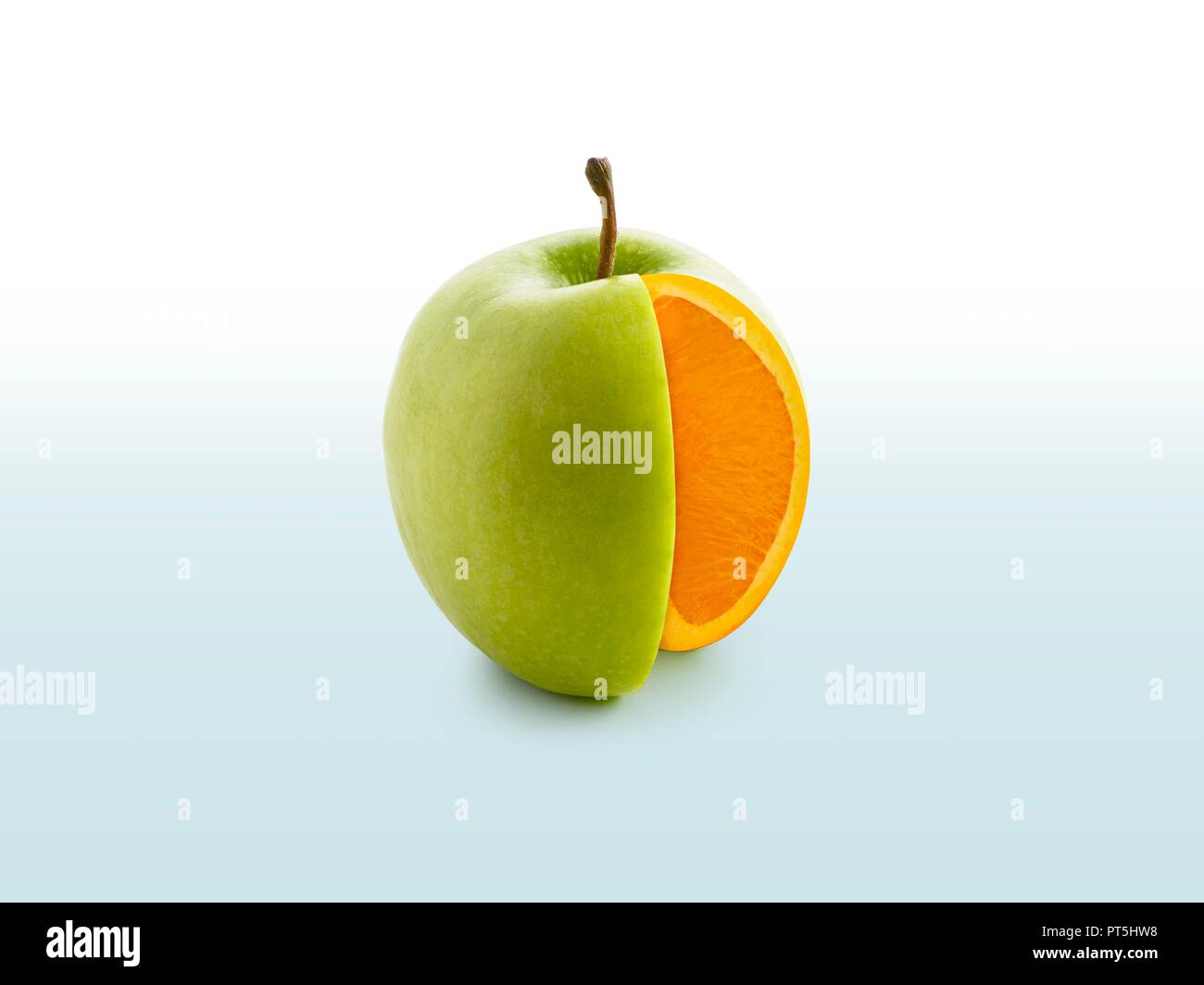 Segment cut from apple showing orange inside Stock Photo - Alamy