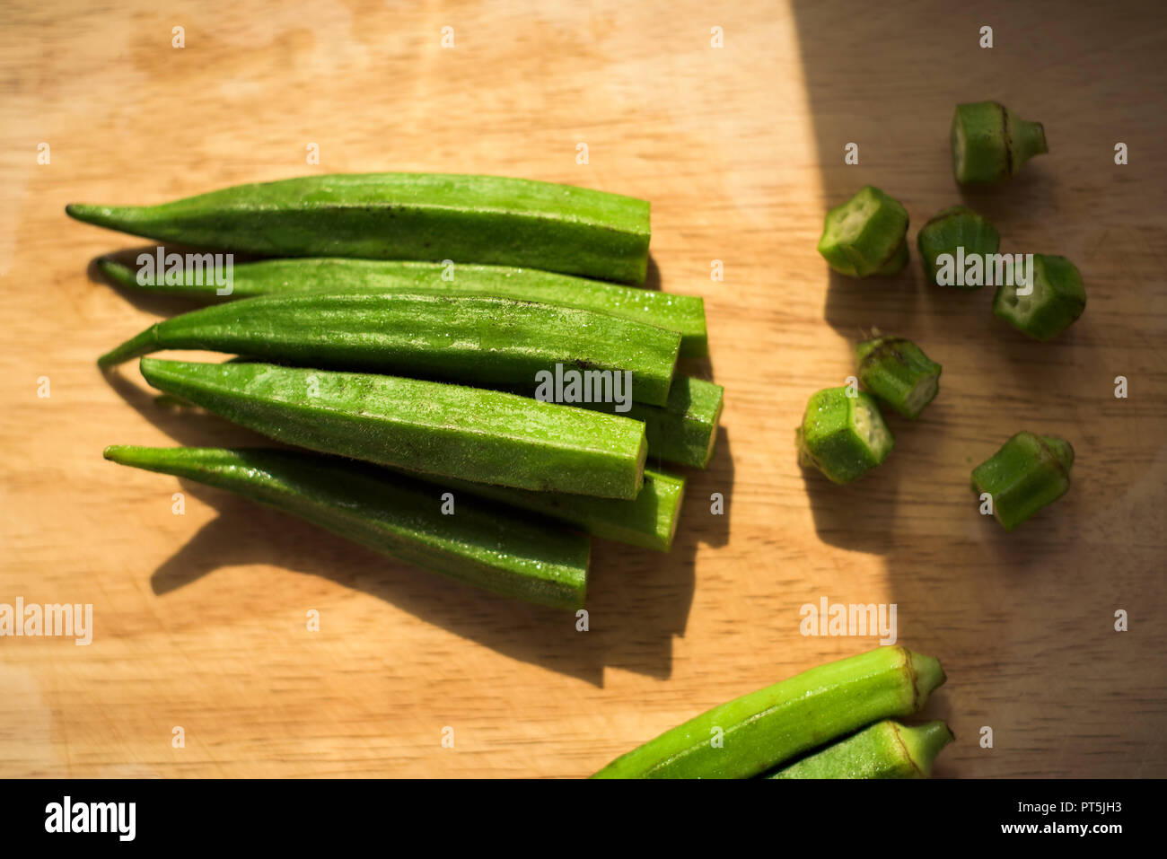 Ladies fingers vegetable on a cutting board top view Stock Photo - Alamy