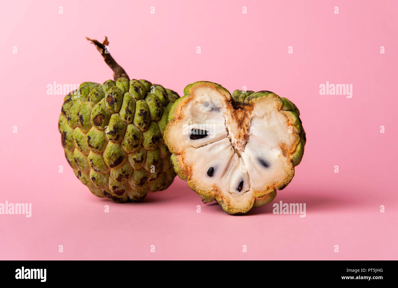 Custard apple fruit on a pink background Stock Photo - Alamy