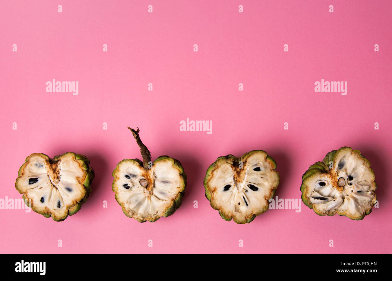 Custard apple fruit on a pink background Stock Photo - Alamy