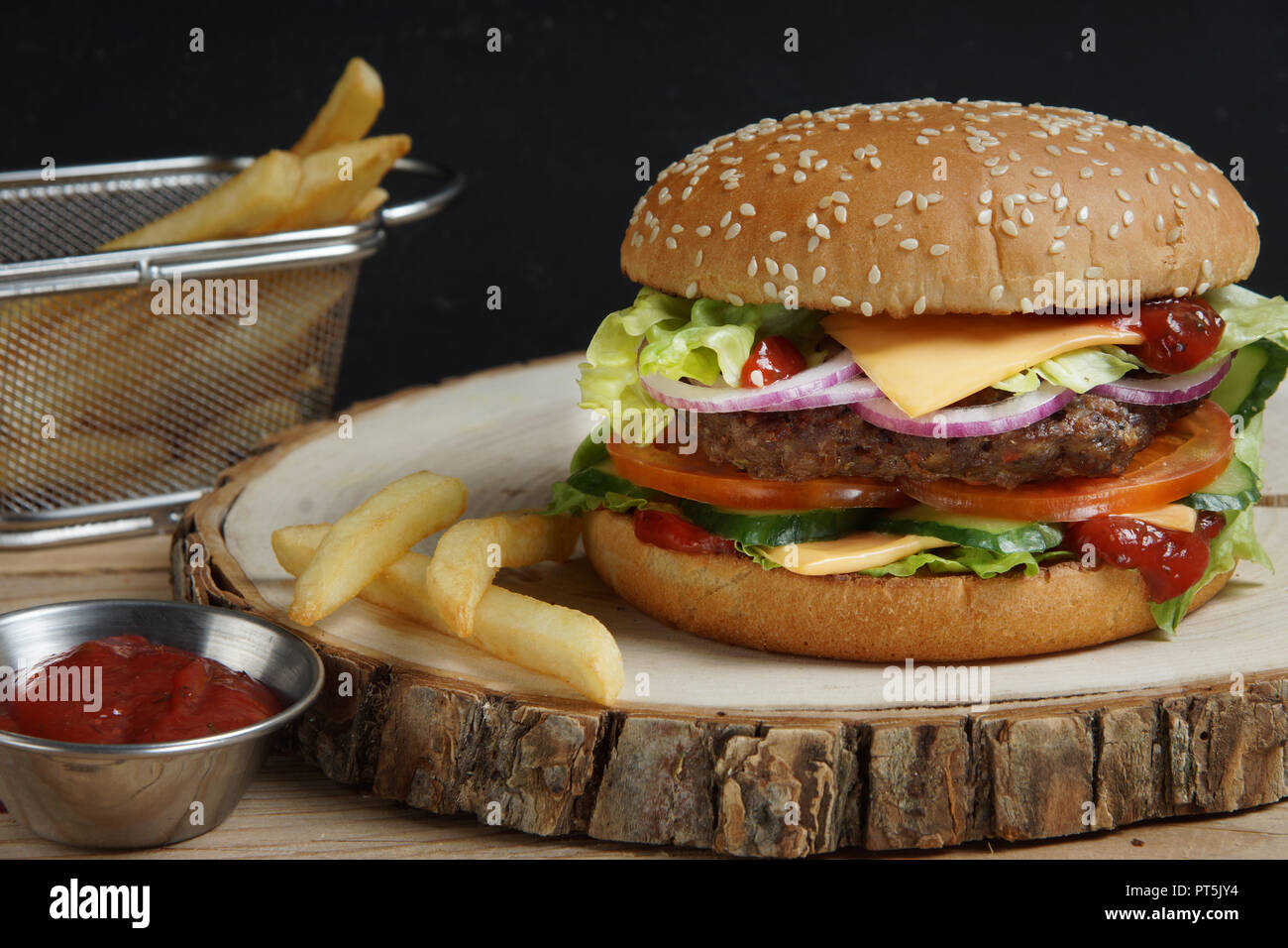 A savory large burger with a meatball, tomatoes, cucumbers, cheese ...