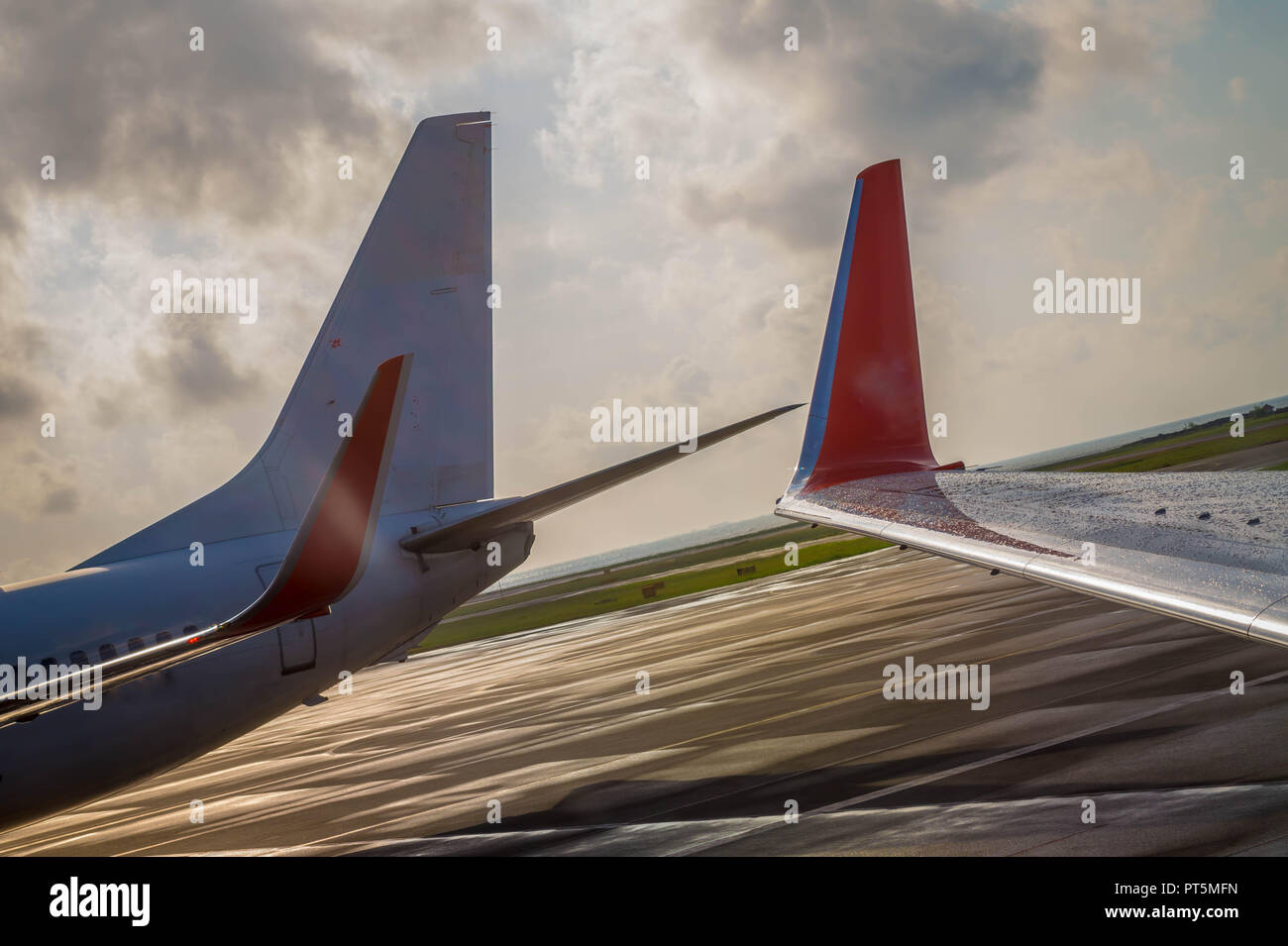 wing and tail of the airplanes in the airport with sky as the ...