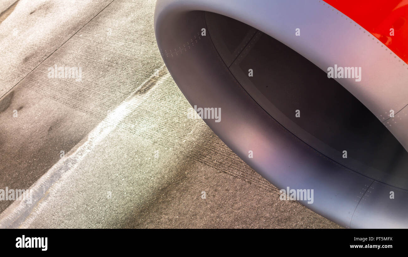 jet engine of the airplane with runaway tarmac as the background ...