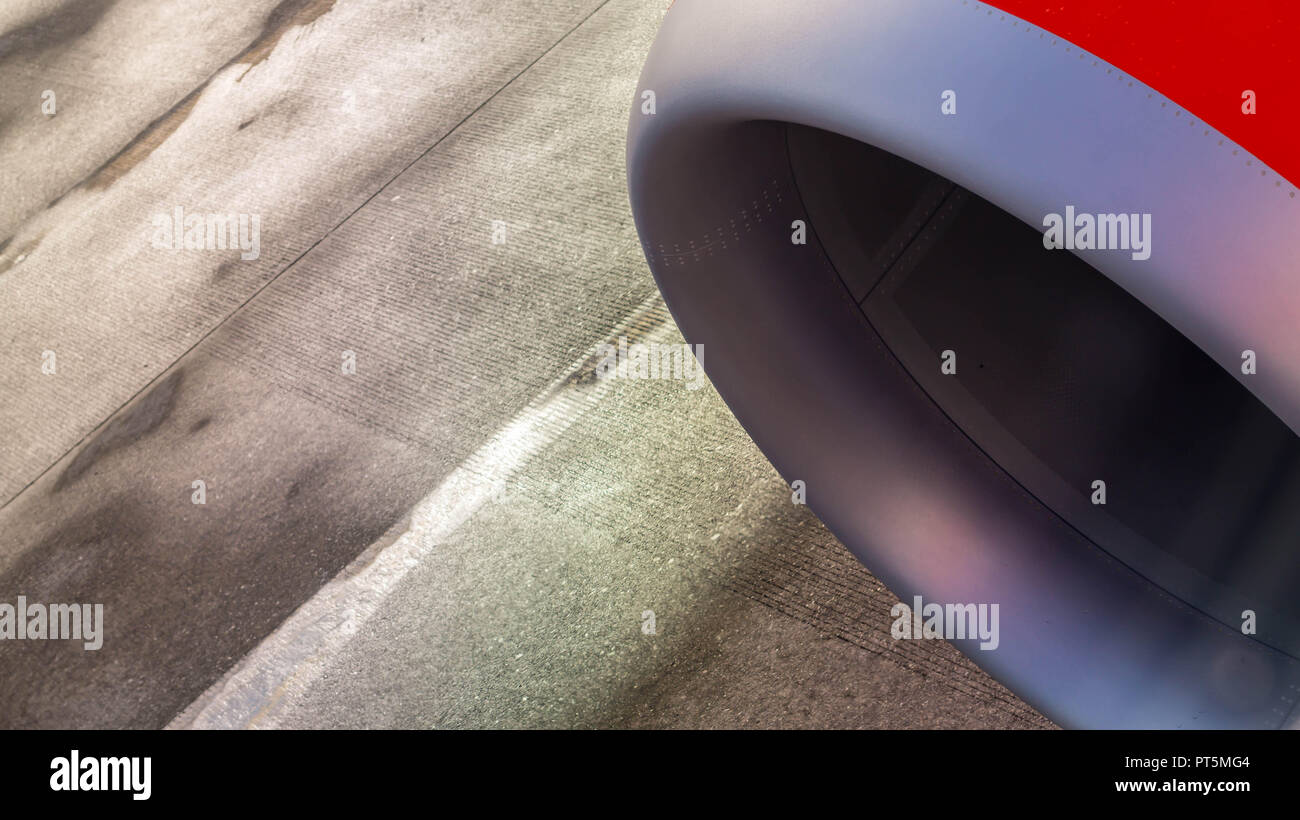 jet engine of the airplane with runaway tarmac as the background ...