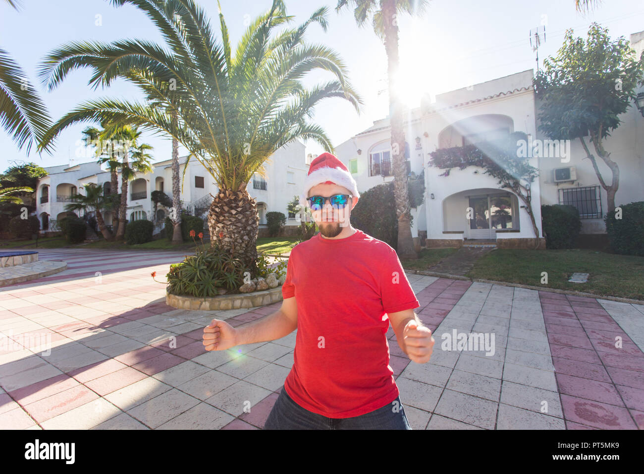 Holidays and people concept - Young attractive man dancing in Santa ...