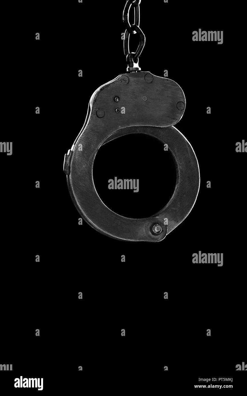 steel handcuffs of police special equipment, fetters on a black ...