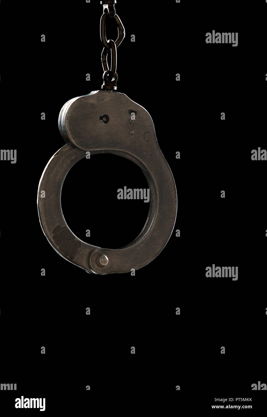 steel handcuffs of police special equipment, fetters on a black ...