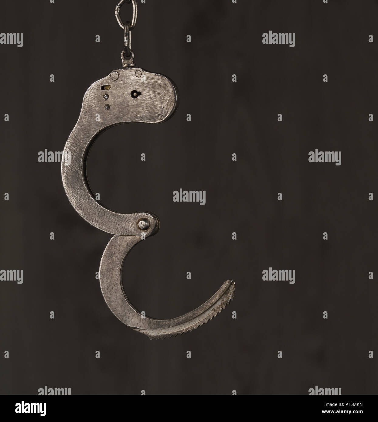 steel handcuffs of police special equipment, fetters on a black ...