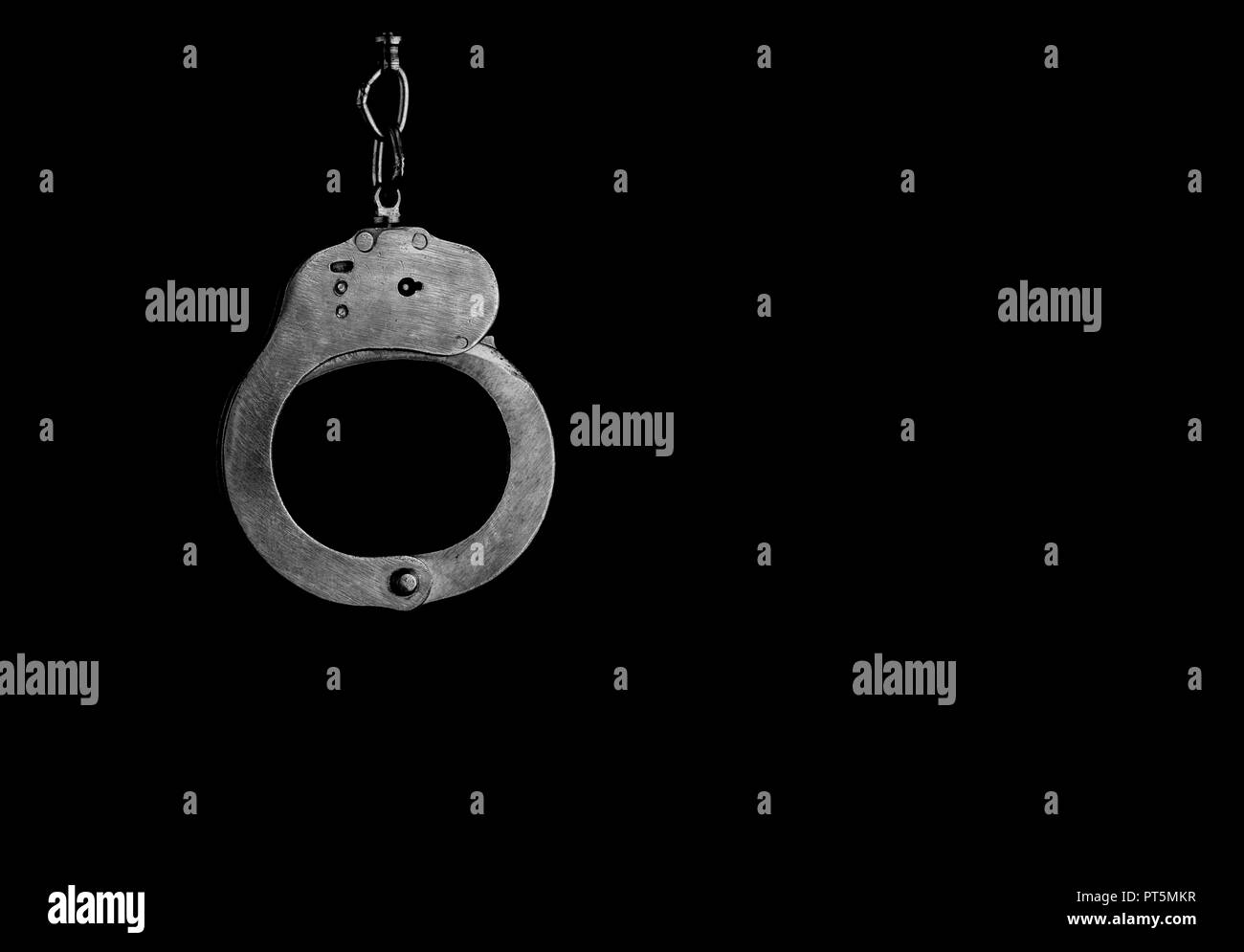 steel handcuffs of police special equipment, fetters on a black ...