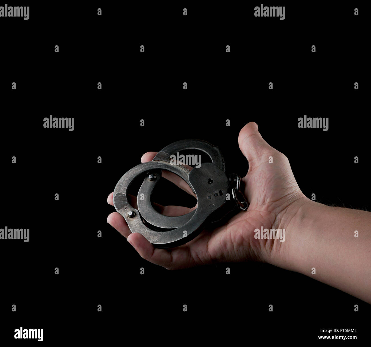steel handcuffs of police special equipment, fetters on a black ...