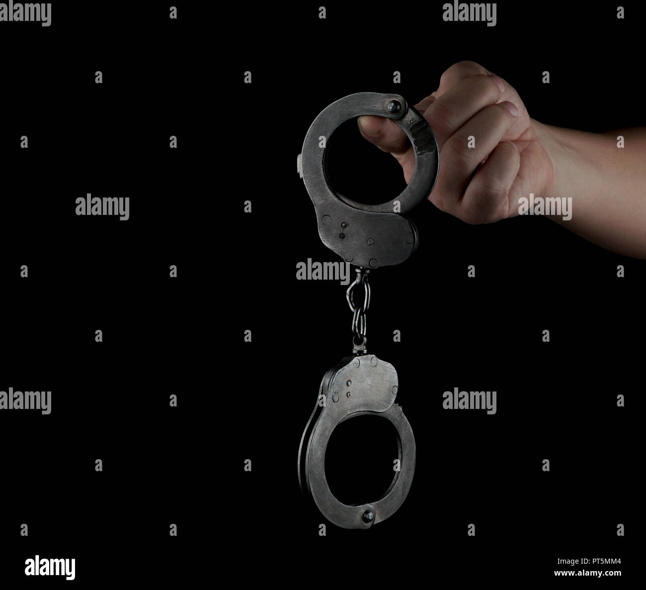 steel handcuffs of police special equipment, fetters on a black ...
