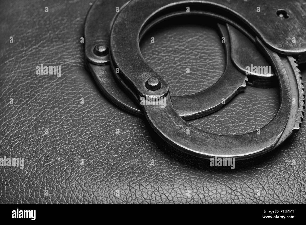 steel handcuffs of police special equipment, fetters on a black ...