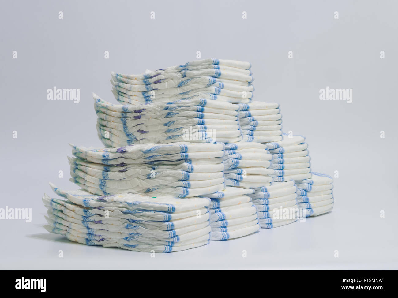 Stacks of diapers stacked in staggered rows on a white background Stock ...