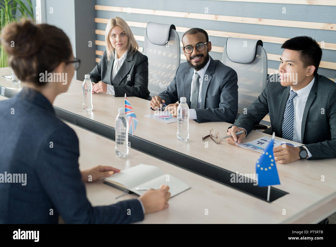 Positive confident multi-ethnic politicians in formal suits sitting at ...