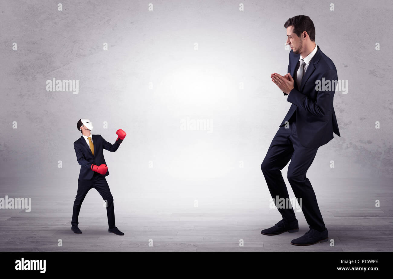 Big businessman being afraid of small masked businessman with box ...