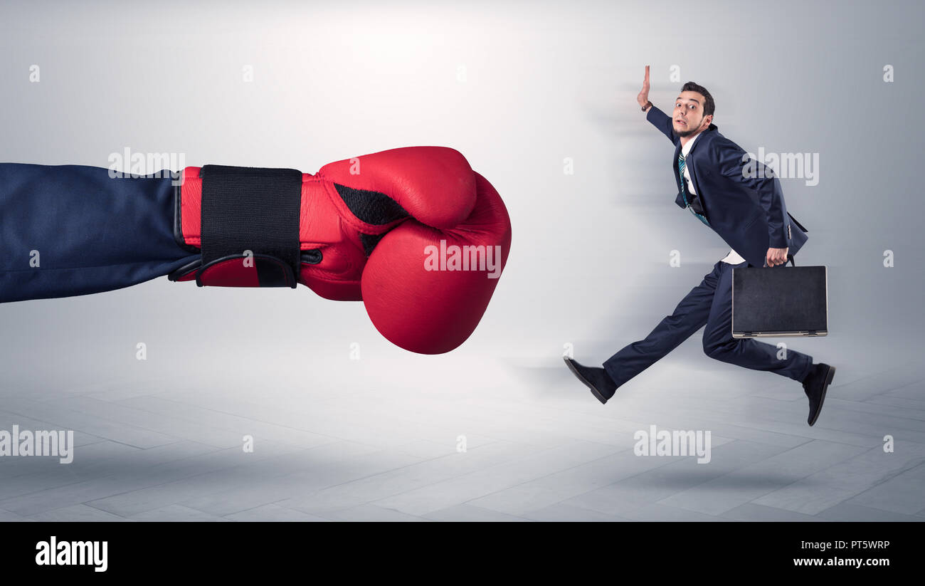 Giant hand gives a kick to a small employee businessman Stock Photo - Alamy