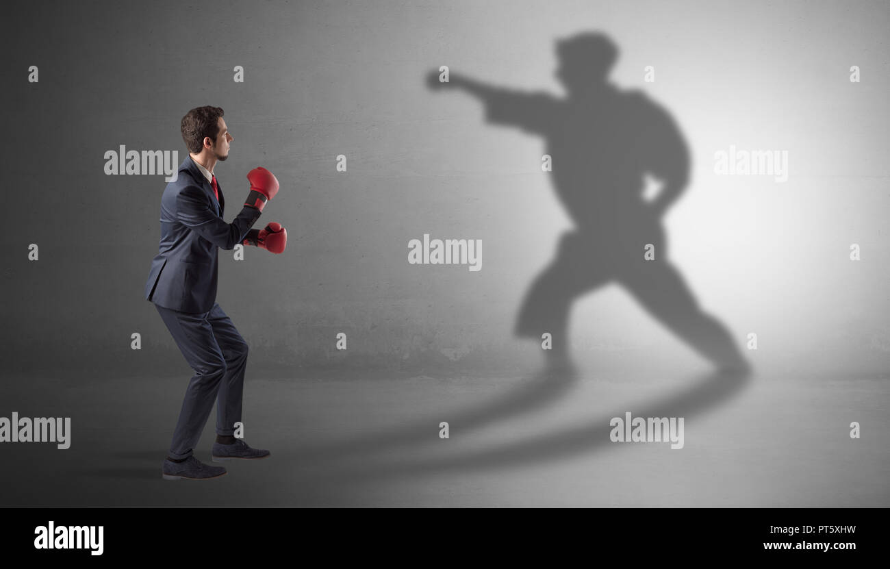 Businessman fighting with his strong karate man shadow Stock Photo - Alamy