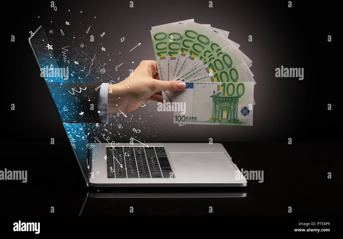 Hand with money coming out of a laptop with sparkling effects Stock ...