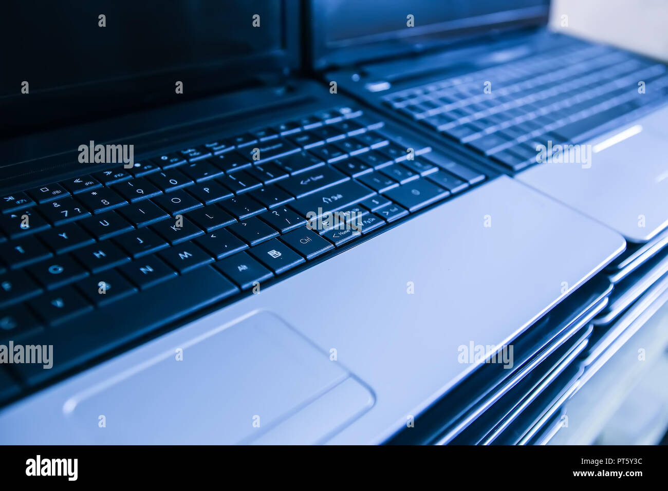 Piles on laptops with open keyboards. Closeup Stock Photo - Alamy