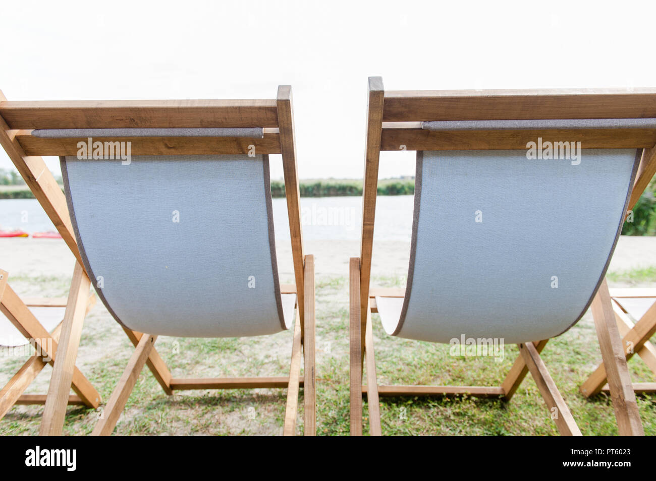 Two wooden lounge relax chairs from back Stock Photo - Alamy