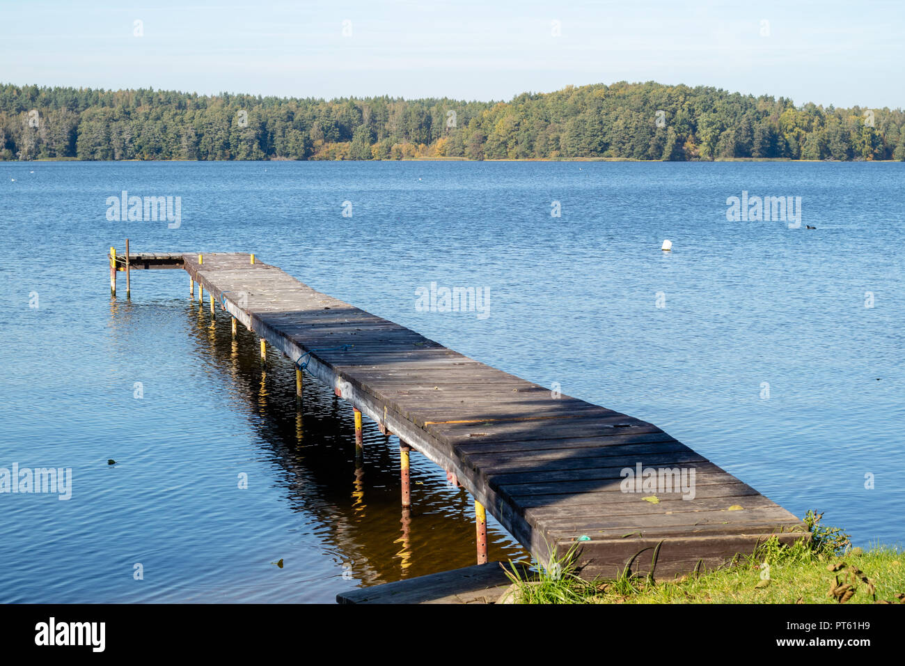 An old bridge over the lake. A place for mooring vessels. Season of the ...