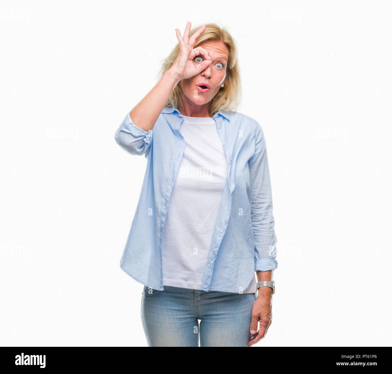 Middle age blonde woman over isolated background doing ok gesture ...
