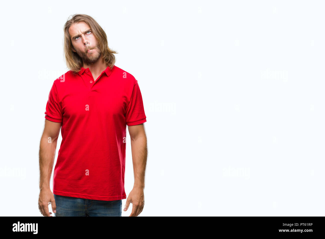 Young handsome man with long hair over isolated background making fish ...