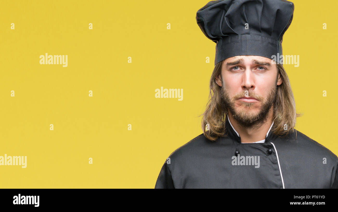 Young handsome cook man with long hair over isolated background ...