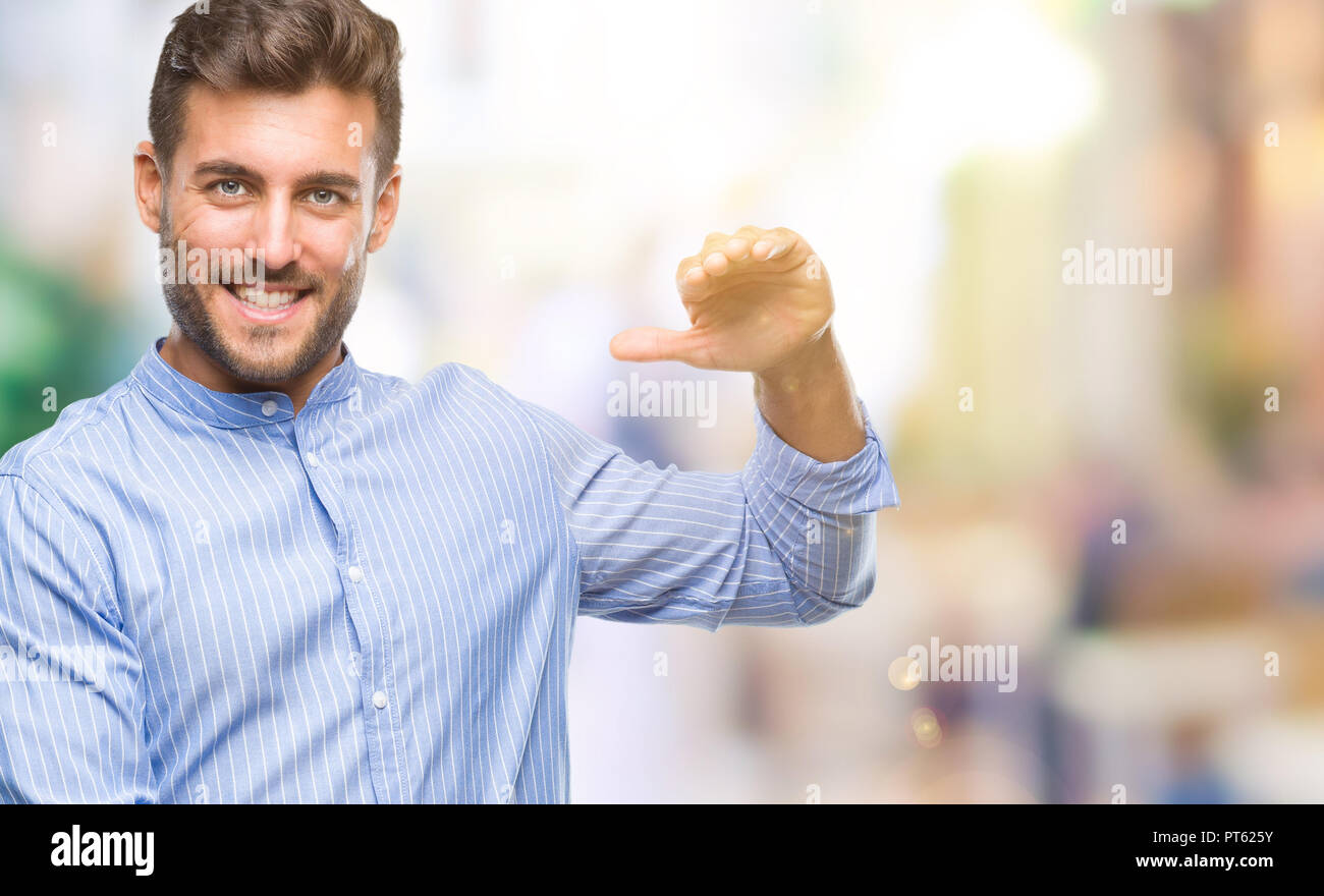 Young handsome man over isolated background gesturing with hands ...