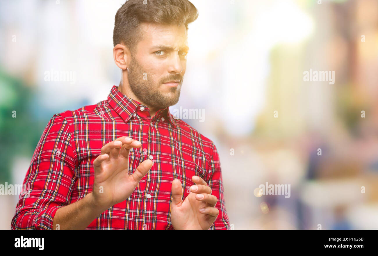 Young handsome man over isolated background disgusted expression ...
