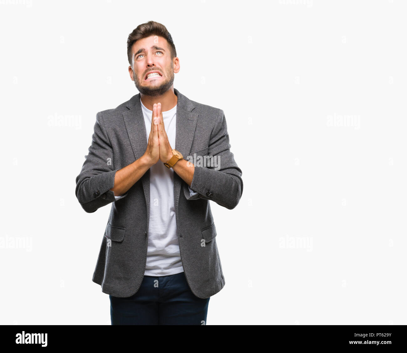 Young handsome business man over isolated background begging and ...