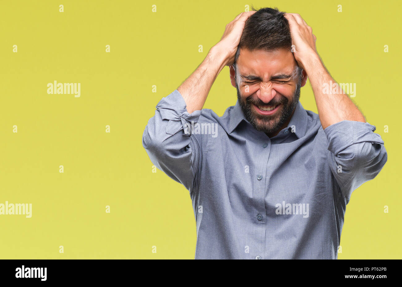 Adult hispanic man over isolated background suffering from headache ...