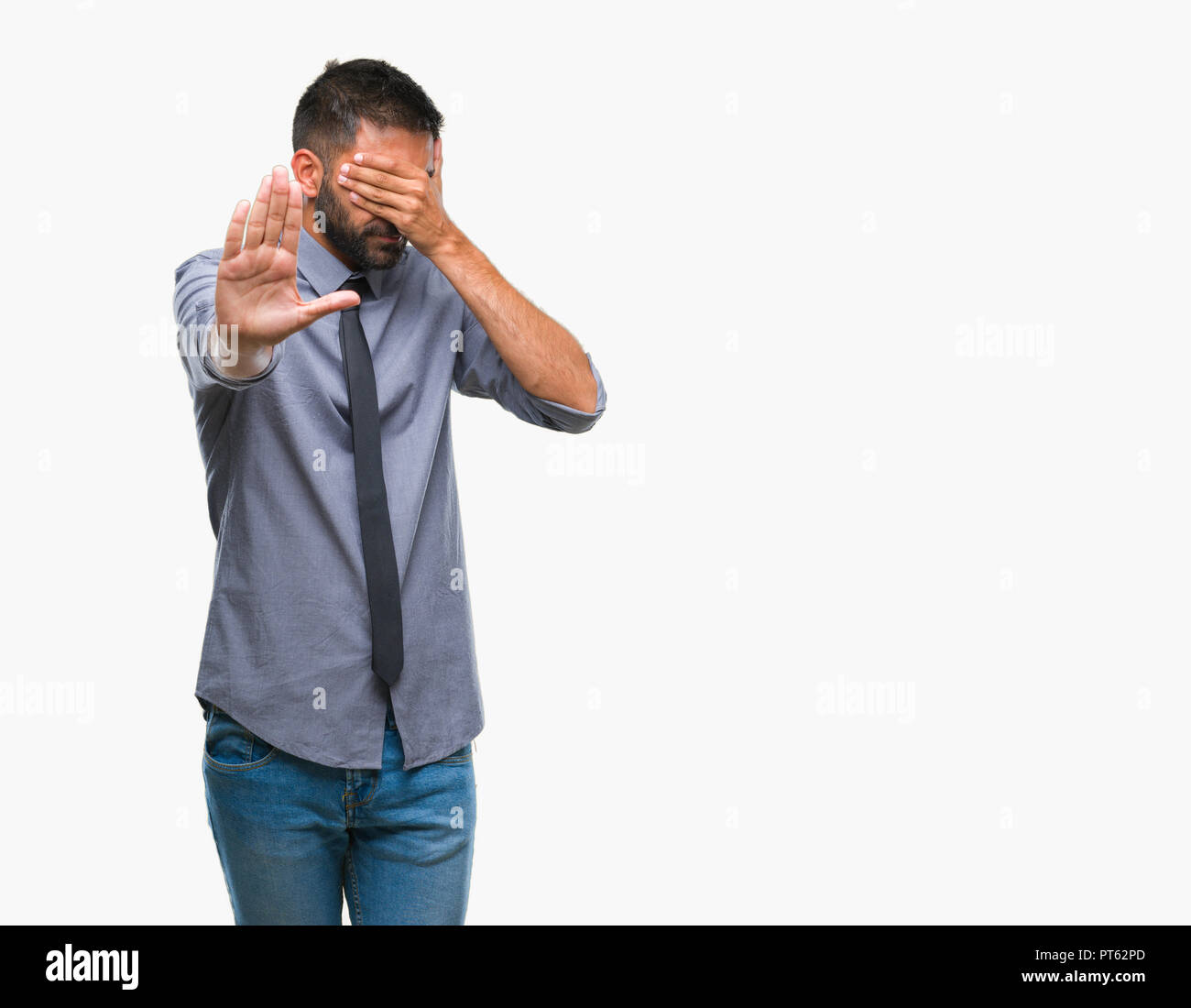 Adult hispanic business man over isolated background covering eyes with ...