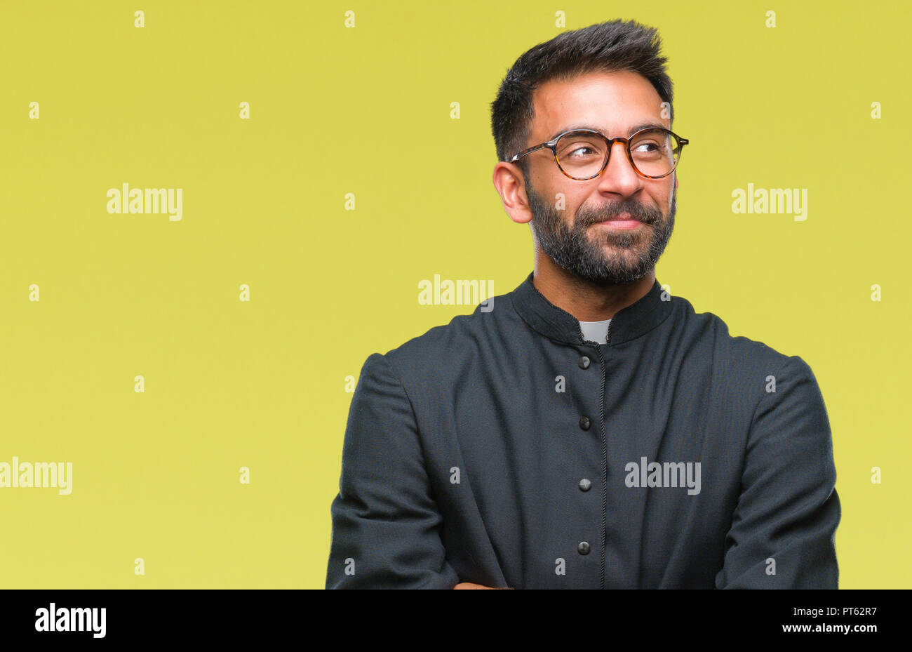 Adult hispanic catholic priest man over isolated background smiling ...
