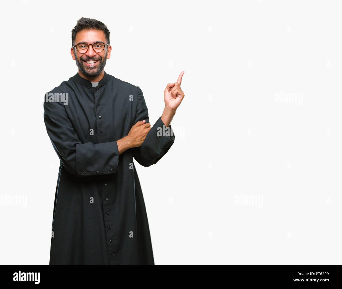 Adult hispanic catholic priest man over isolated background with a big ...