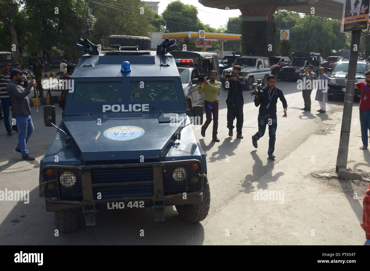 Pakistani Police officers secure an armored vehicle carrying Pakistani ...