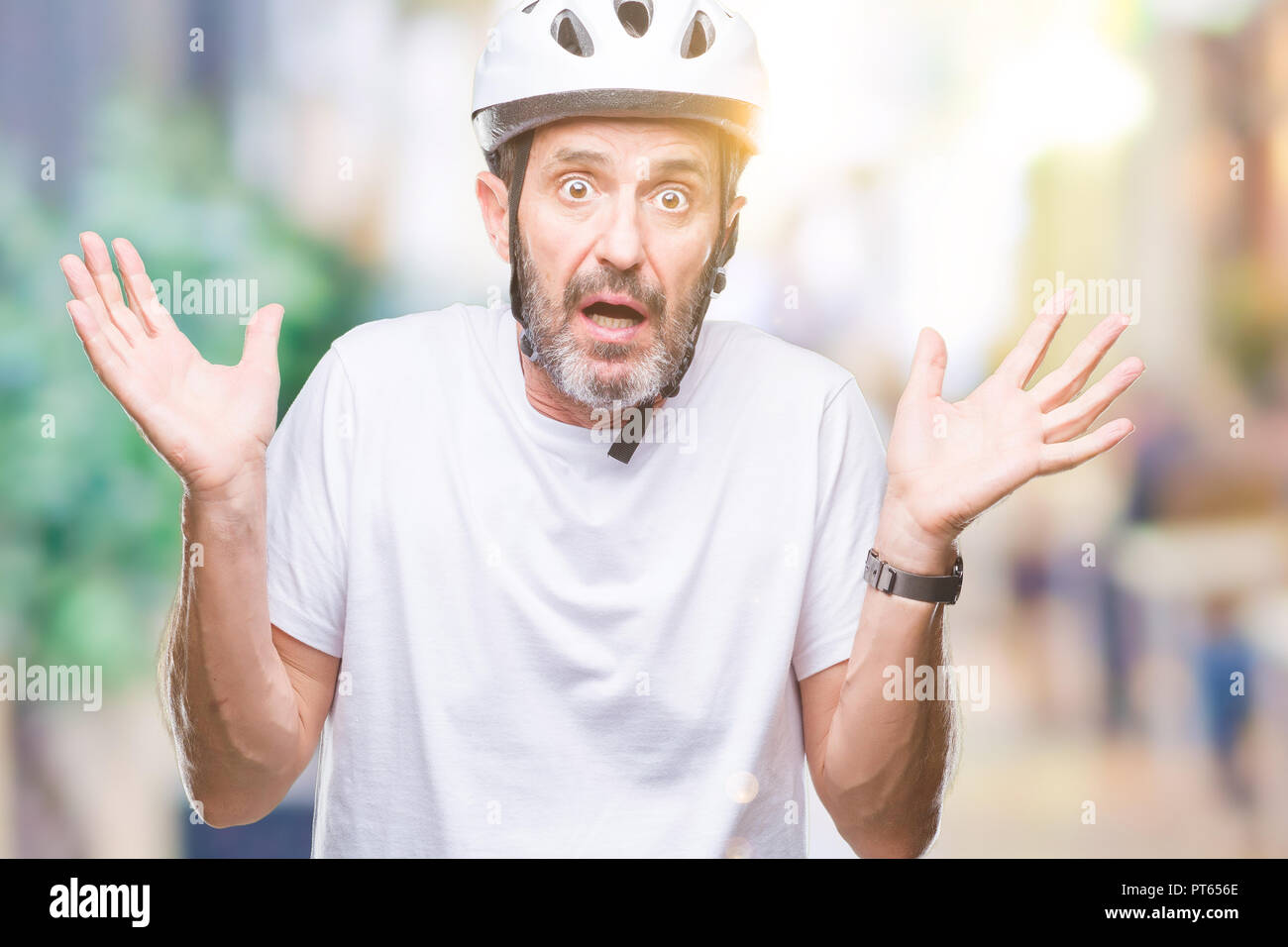 Middle age senior hoary cyclist man wearing bike safety helment ...