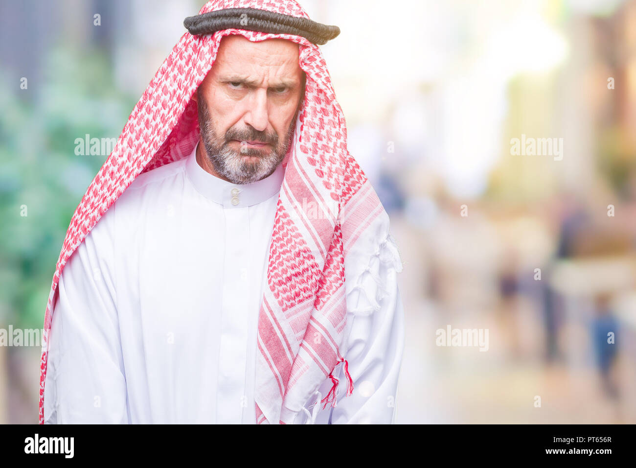 Senior arab man wearing keffiyeh over isolated background skeptic and ...
