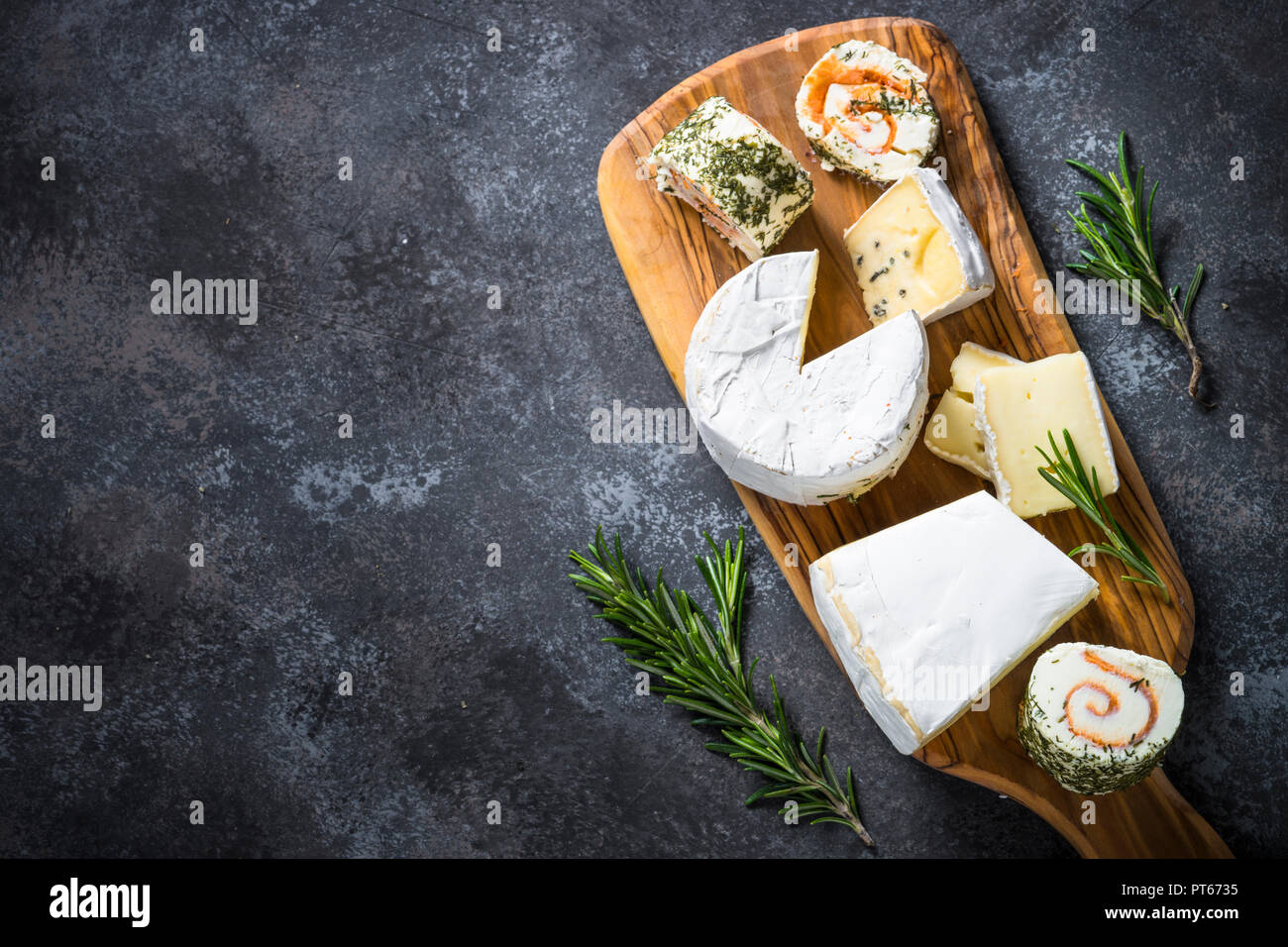 Cheese platter on dark stone table Stock Photo - Alamy