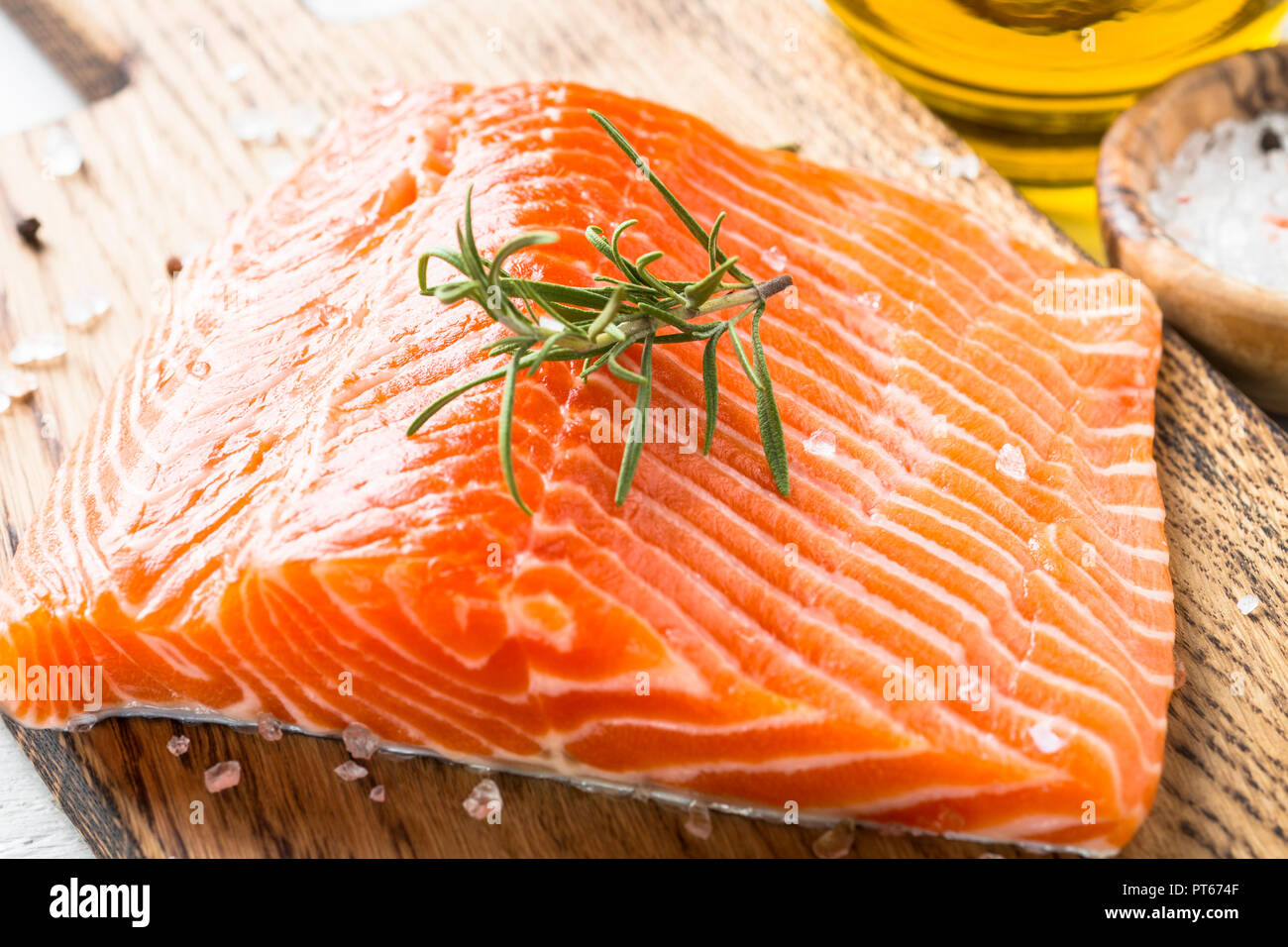 Uncooked salmon fillet with lemon sea salt and rosemary on white Stock ...